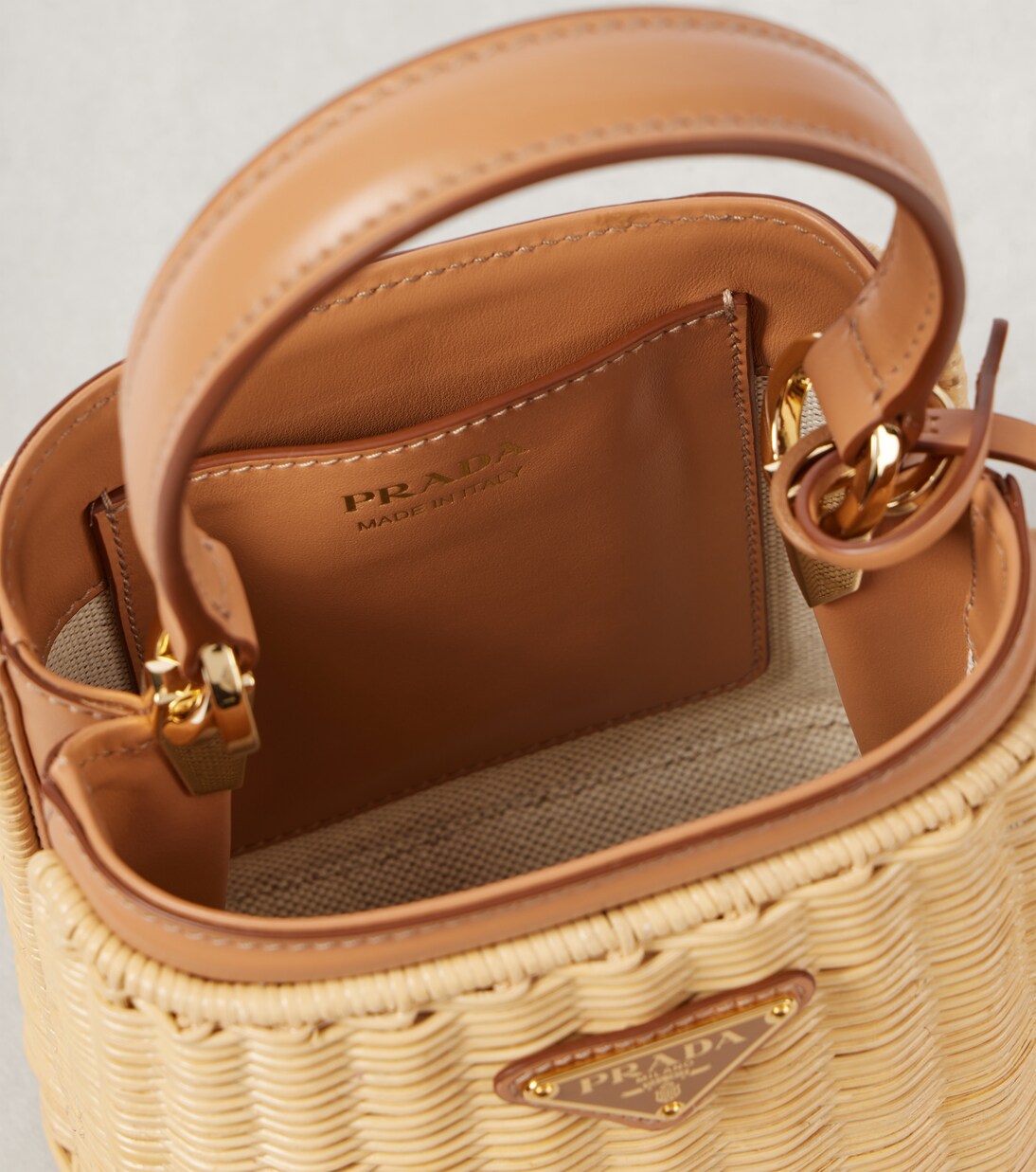 Panier Mini woven leather-trimmed bucket bag in beige - Prada | Mytheresa