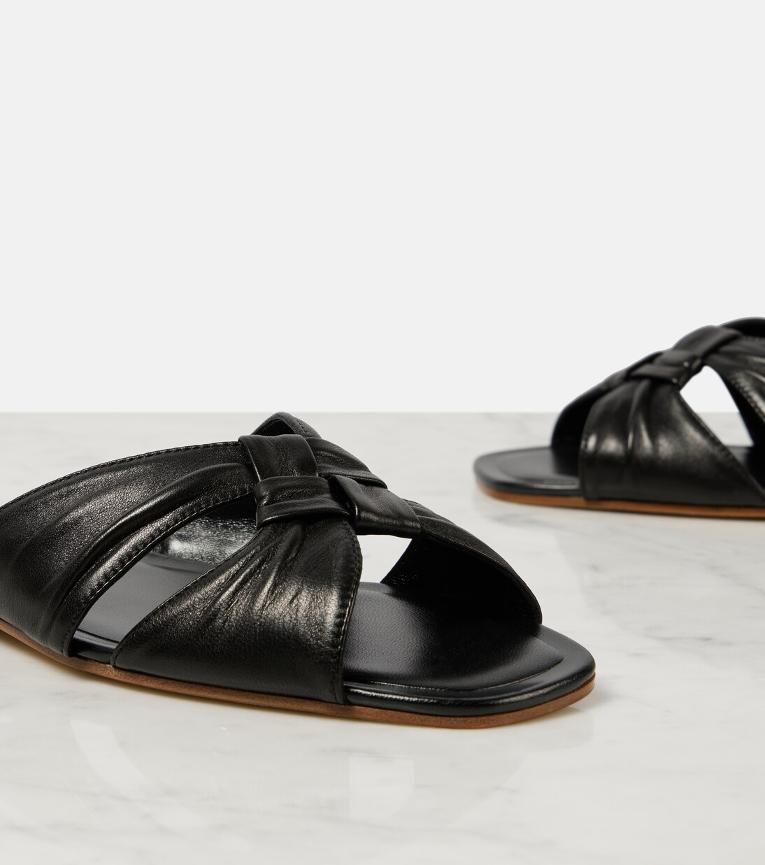 Soft Knot leather slides in black - The Row | Mytheresa