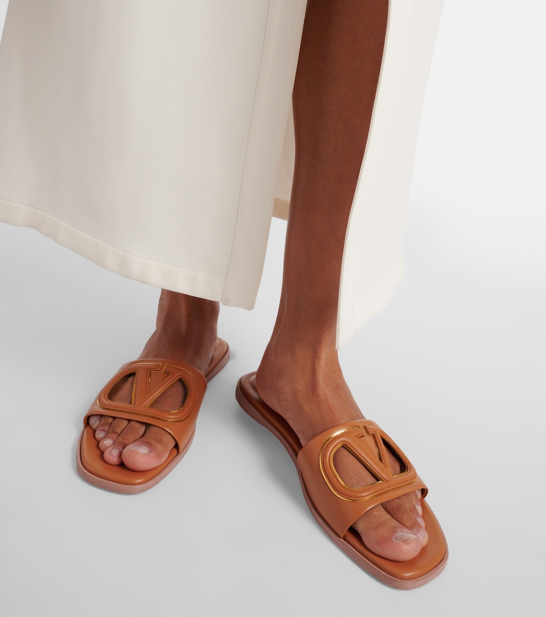 VLogo cutout leather slides in neutrals - Valentino Garavani | Mytheresa