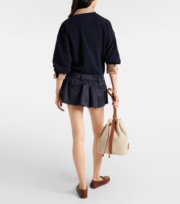 Pleated cotton canvas miniskirt in blue - Miu Miu | Mytheresa